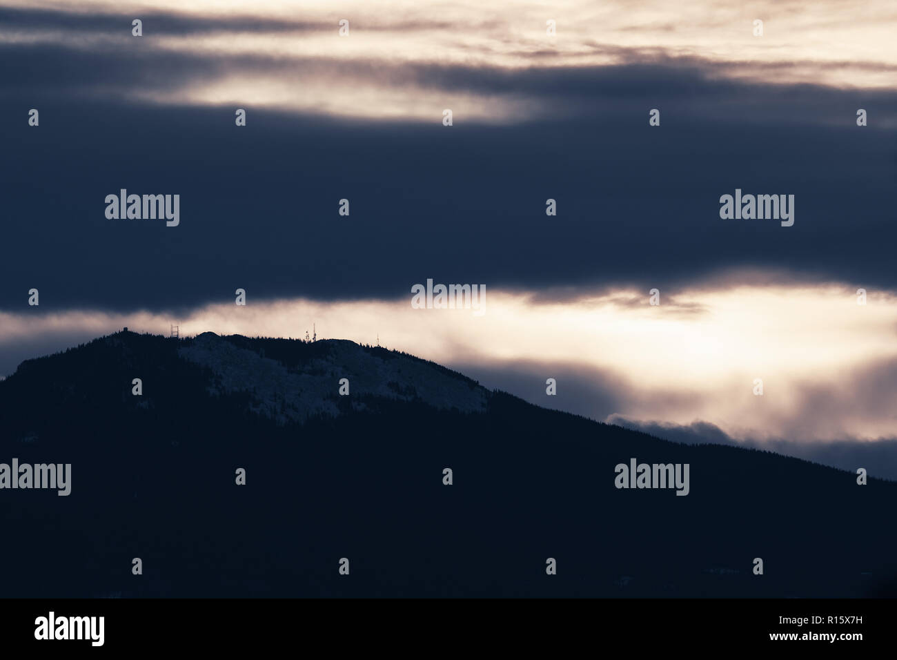 Dramatic winter storm blows over a cold barren landscape near sunset ...