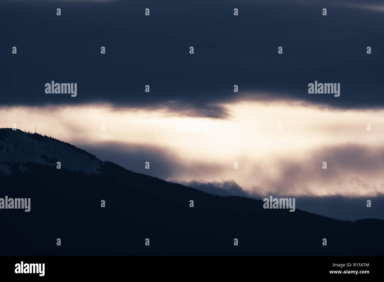 Dramatic winter storm blows over a cold barren landscape near sunset ...