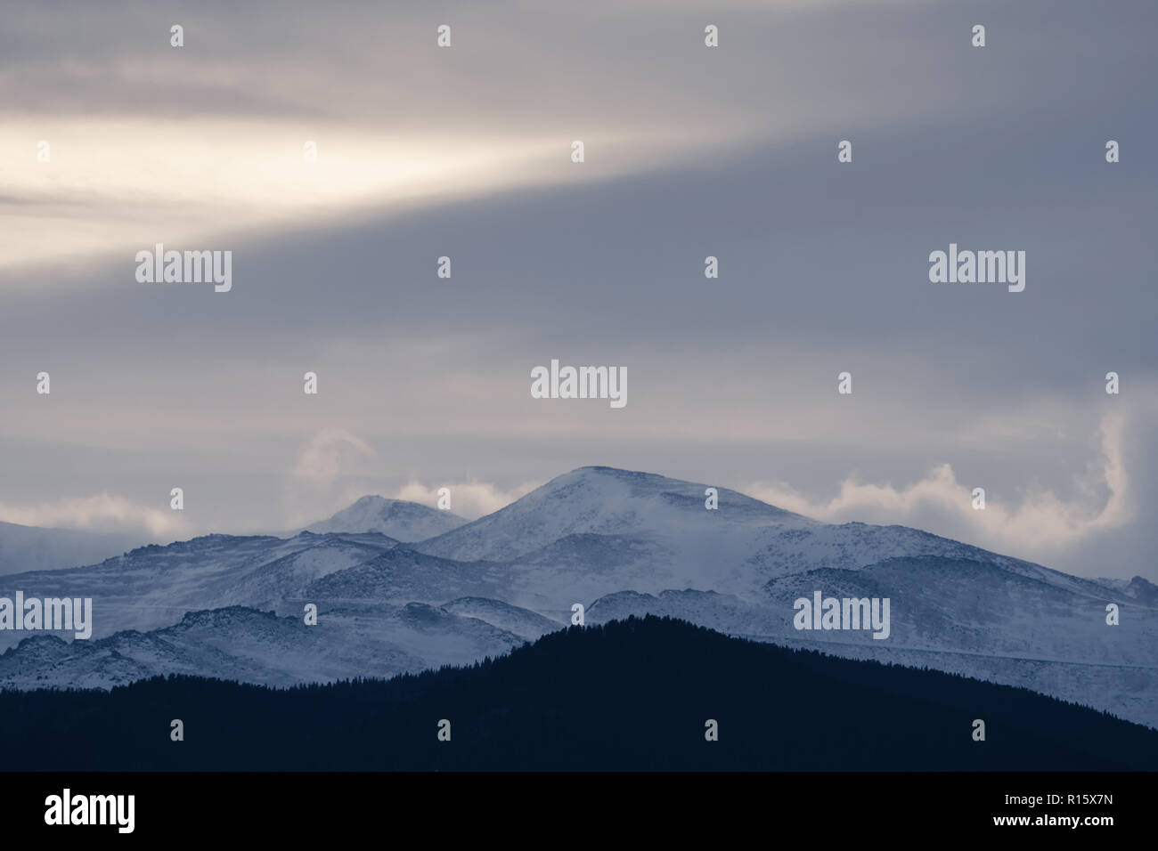 Dramatic winter storm blows over a cold barren landscape near sunset ...