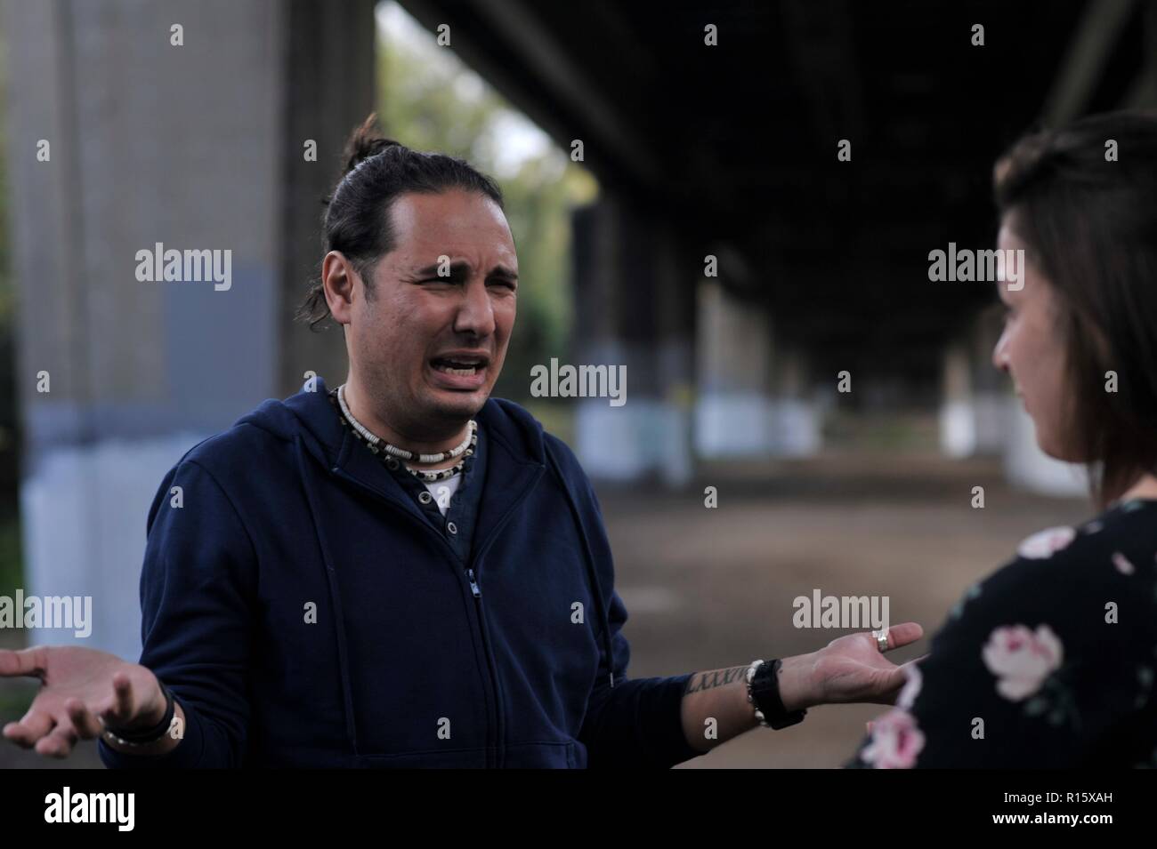 Young couple arguing in public Stock Photo - Alamy