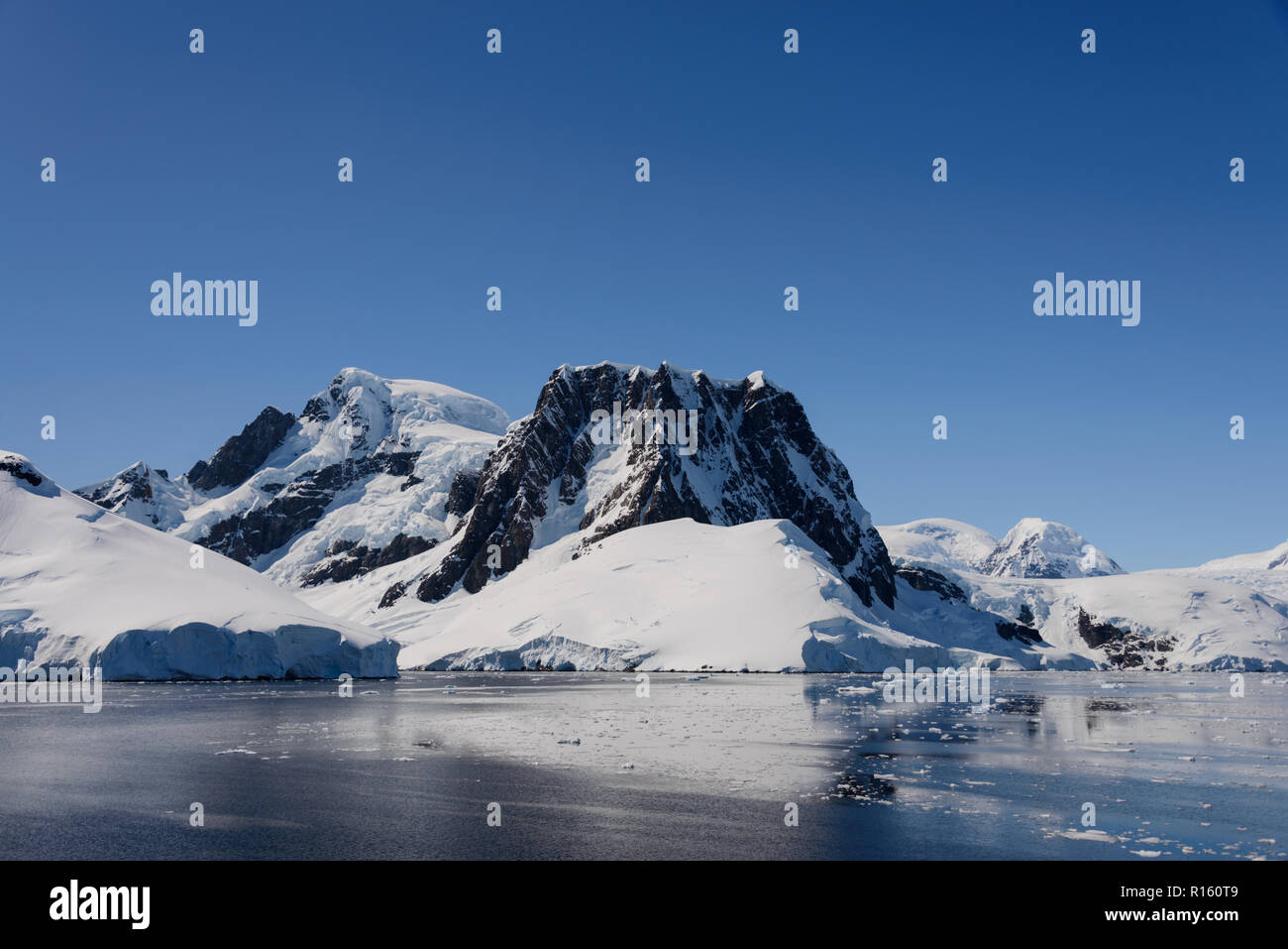 Antarctic landscape with mountains and reflection view from sea ...