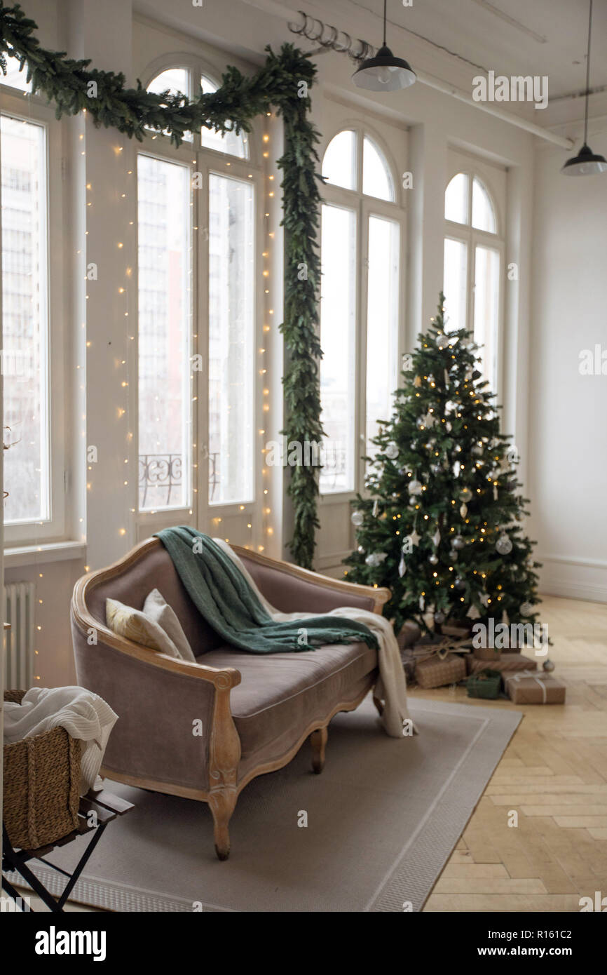 Sofa and Christmas tree near windows Stock Photo - Alamy