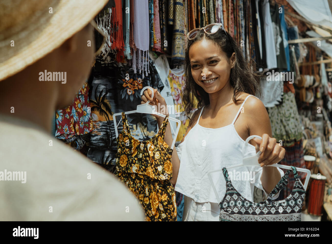 woman buying some clothes in souvenir shop Stock Photo - Alamy