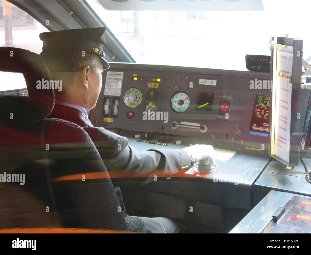 Japanese train driver seated in his cab on a Limited Express Sonic to ...