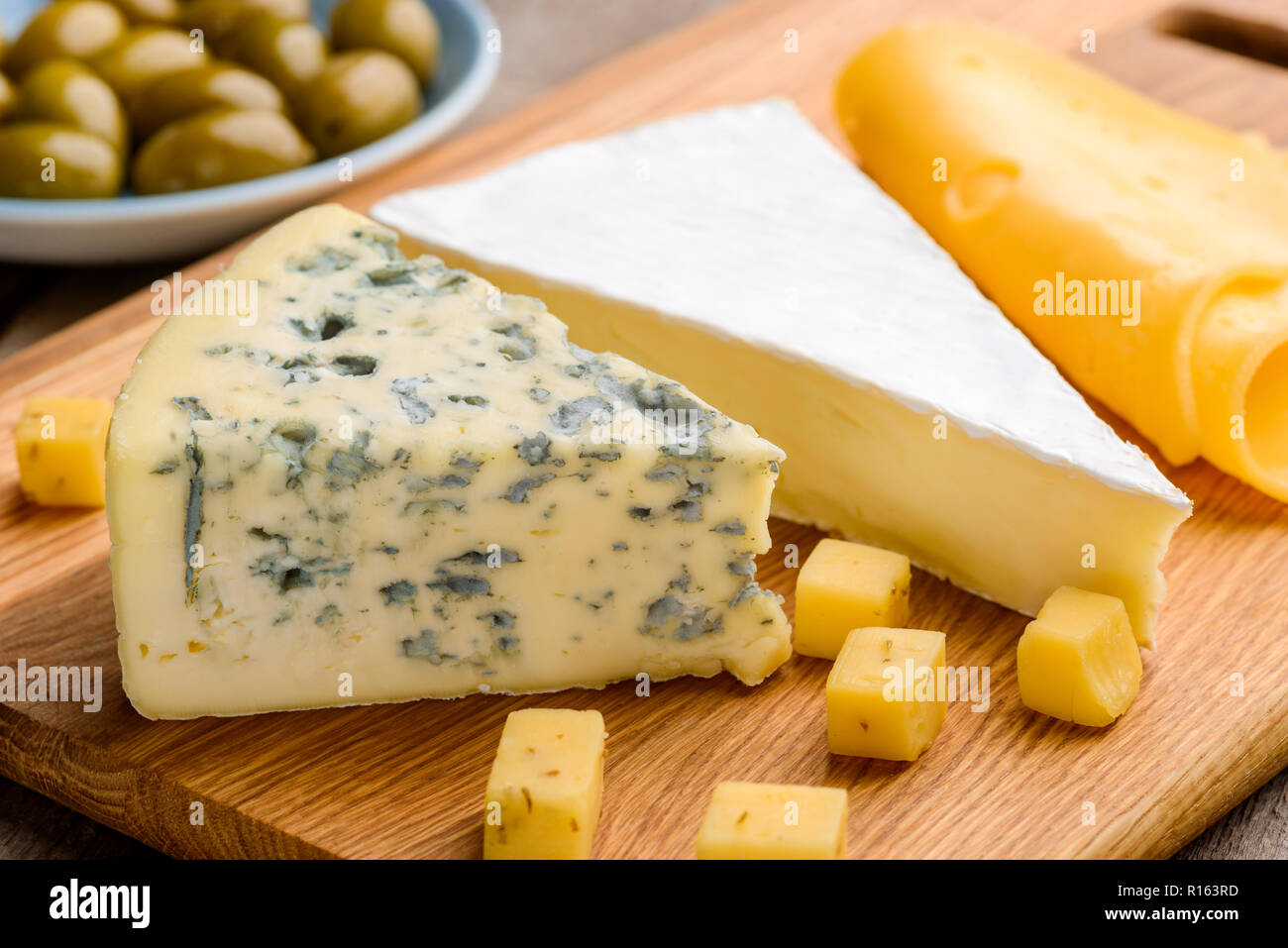 Four cheeses on board Stock Photo - Alamy