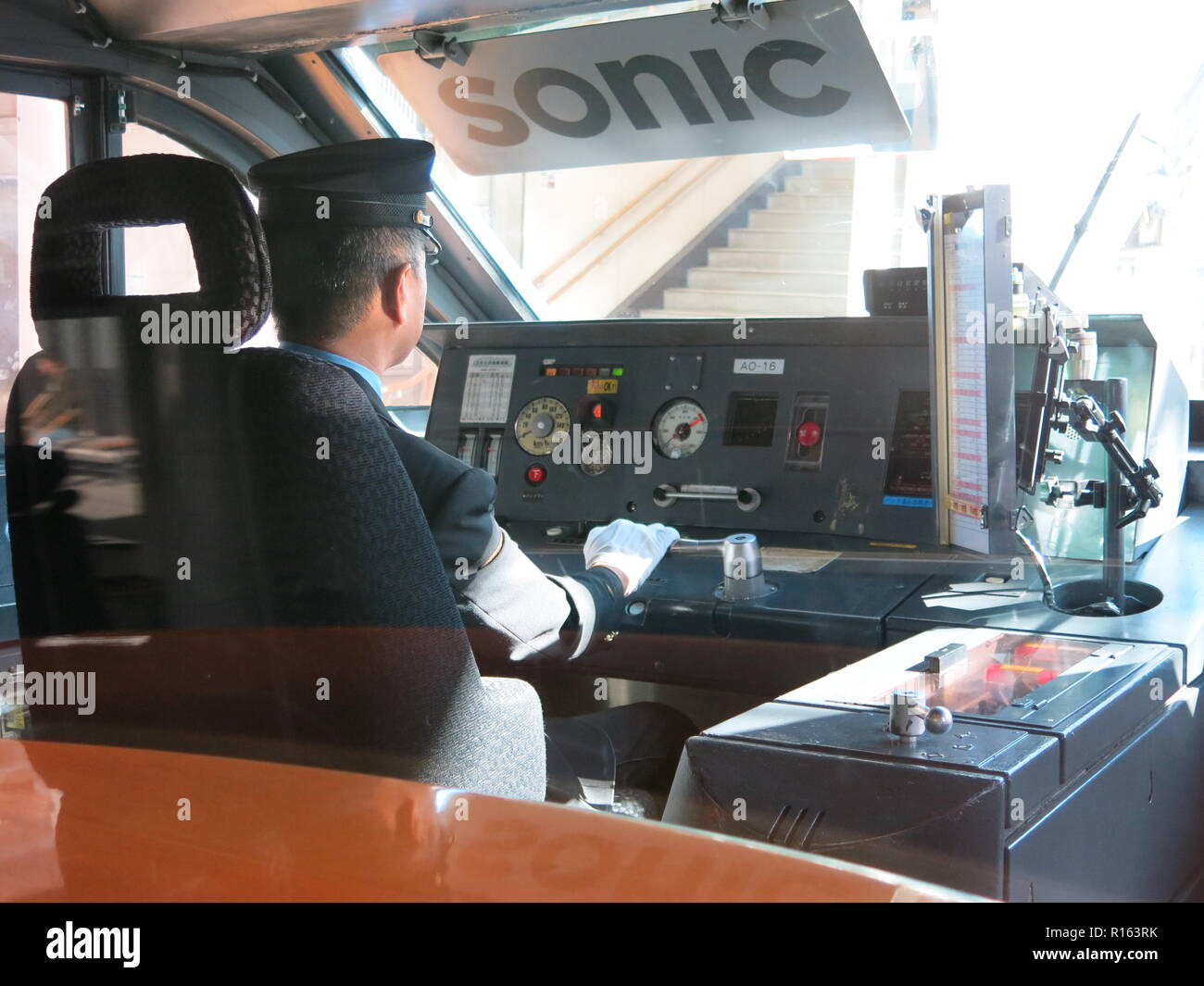 Japanese train driver seated in his cab on a Limited Express Sonic to ...