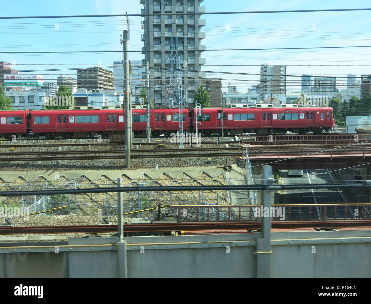 View of a red train on another line as we approach Nagoya station ...
