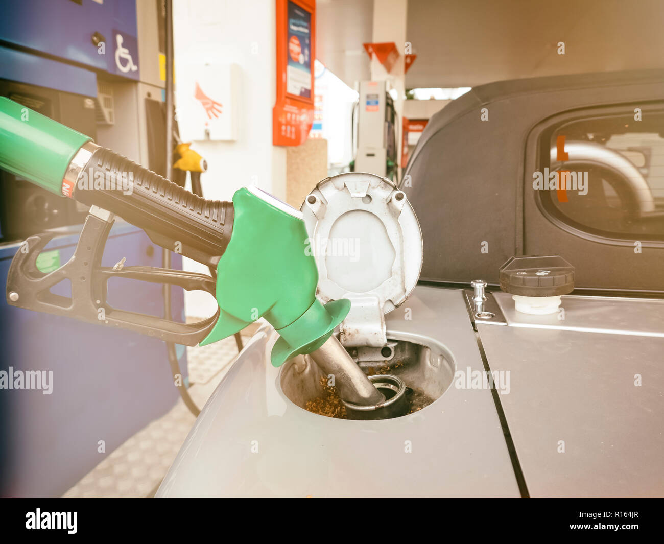 Pump refilling car with fuel at gas station. Oil petrol energy. Close ...