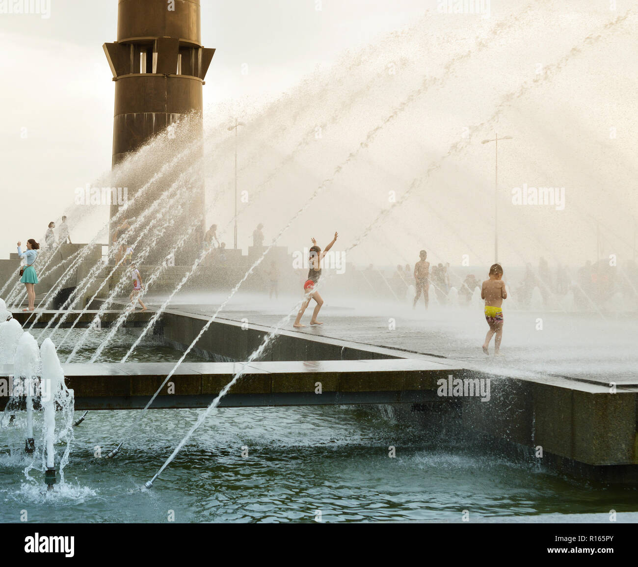 Children frolic in the streams of the fountain Stock Photo - Alamy