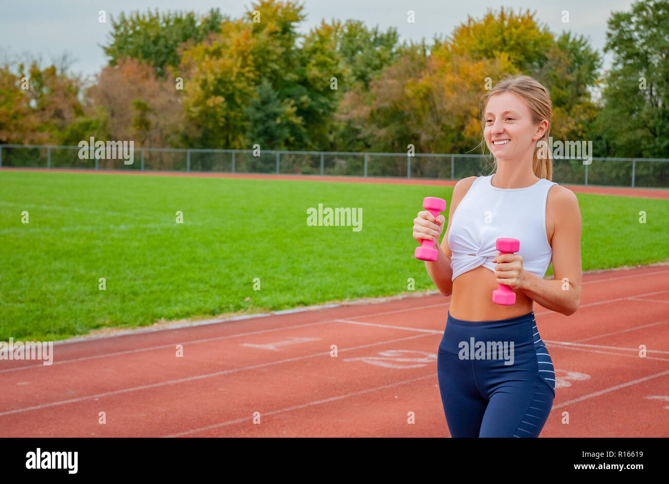 Healthy lifestyle and diet concept. Woman runner with dumbbells is ...