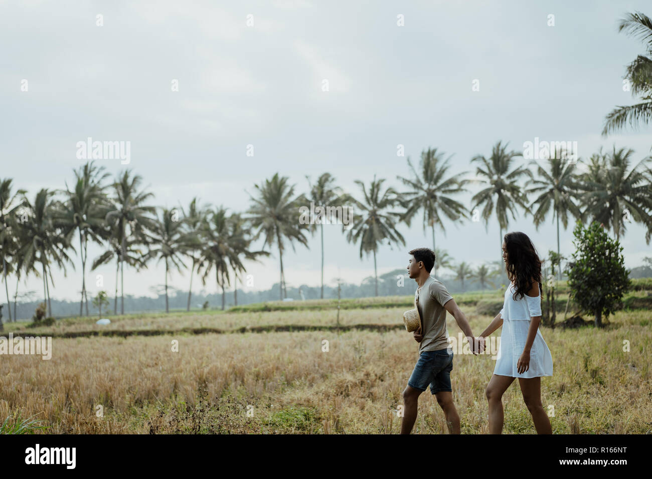 couple stylish walking in rice field together Stock Photo - Alamy