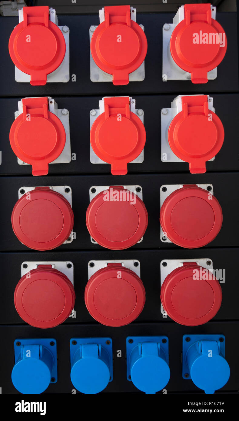 Blue and red generator outdoors with plugs in outlets Stock Photo - Alamy