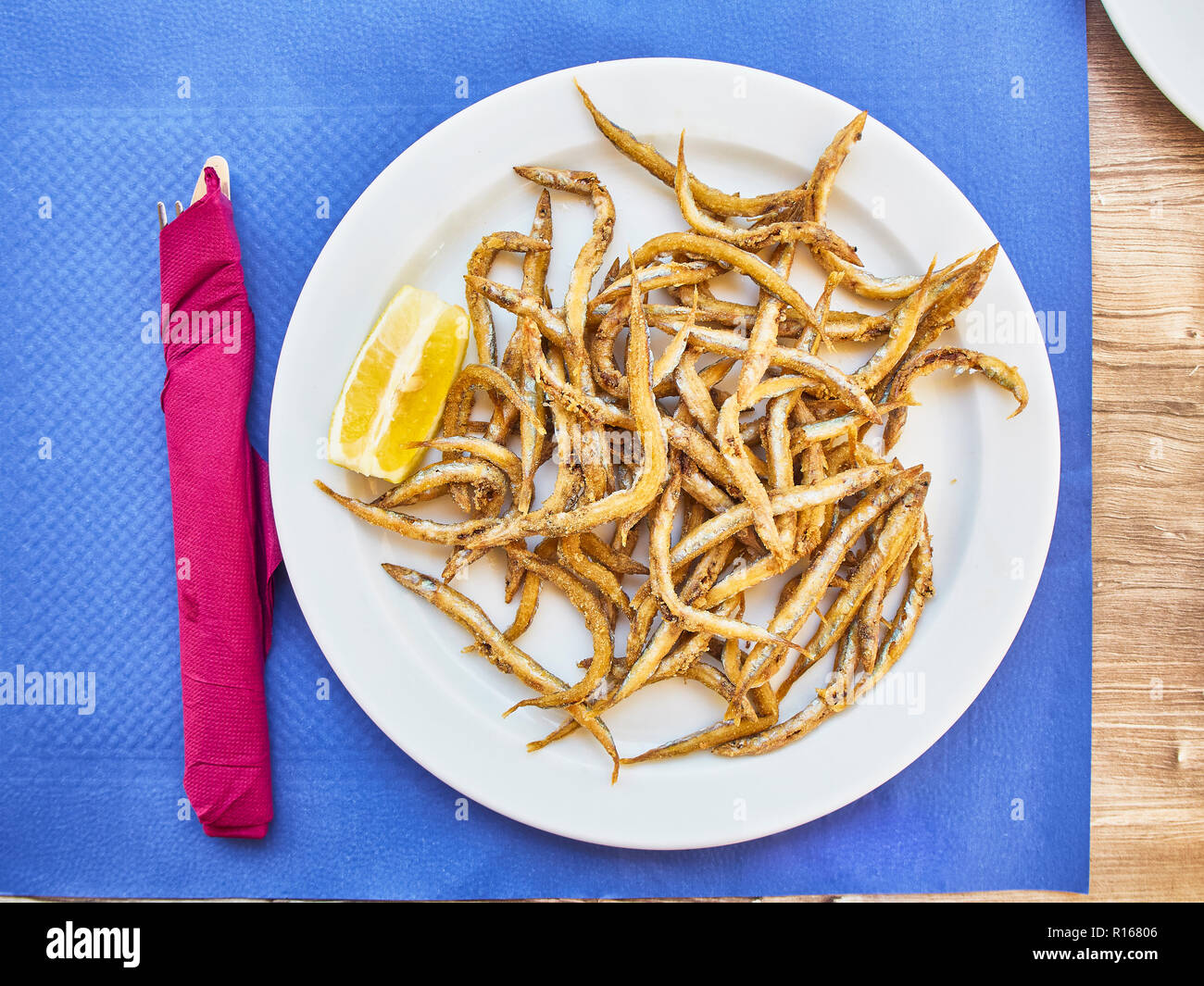 Pescaito frito, fried fish Andalusian style on a tavern table. Spanish ...