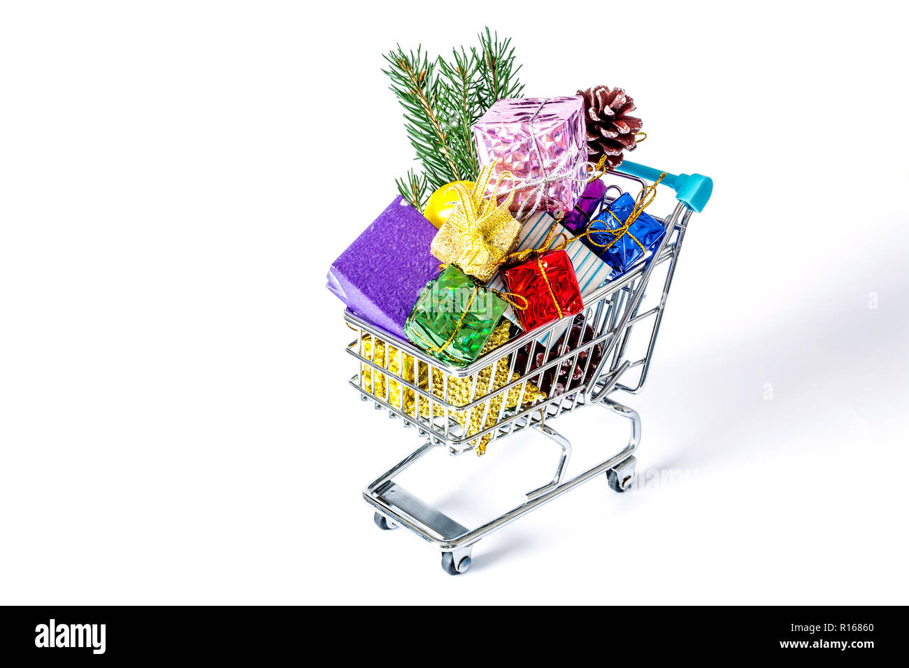 New Year's gifts in a shopping trolley close-up isolated on a white ...
