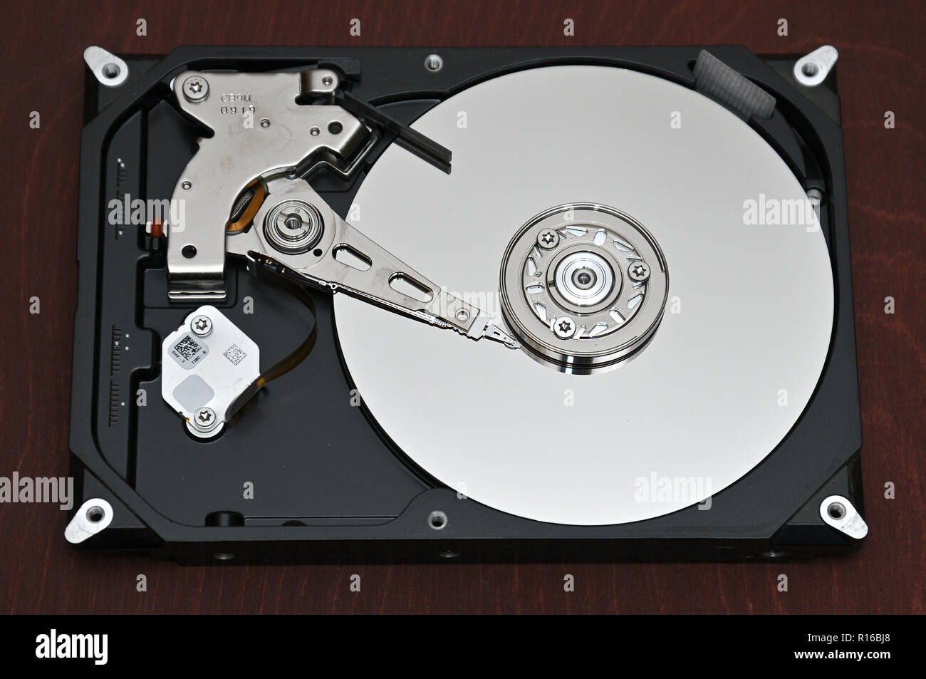 Internal parts of a hard disk on an isolated braun,wood background ...