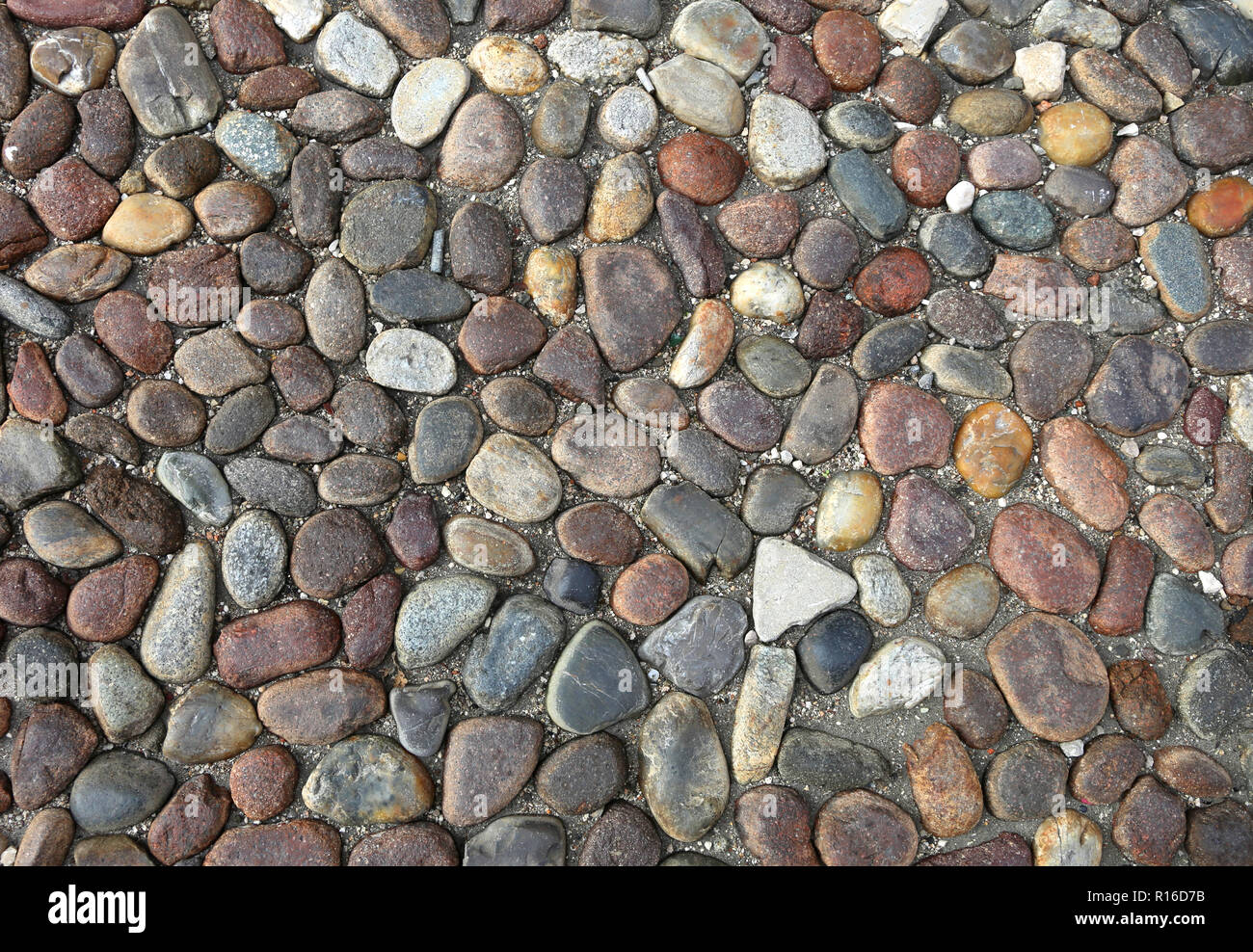 background of polished pebbles stone part of an ancient Roman road ...