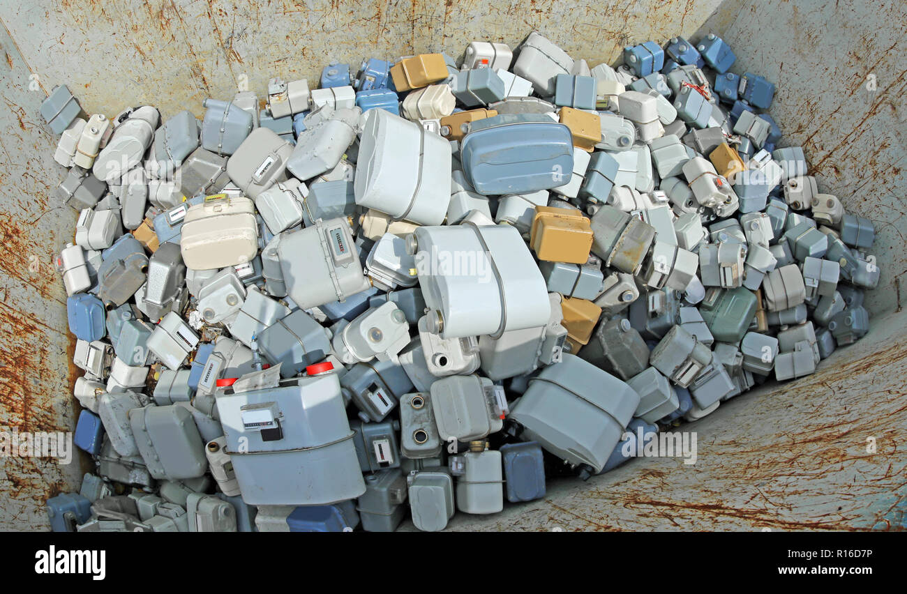 large rusty container in a landfill full of old gas meters no longer ...