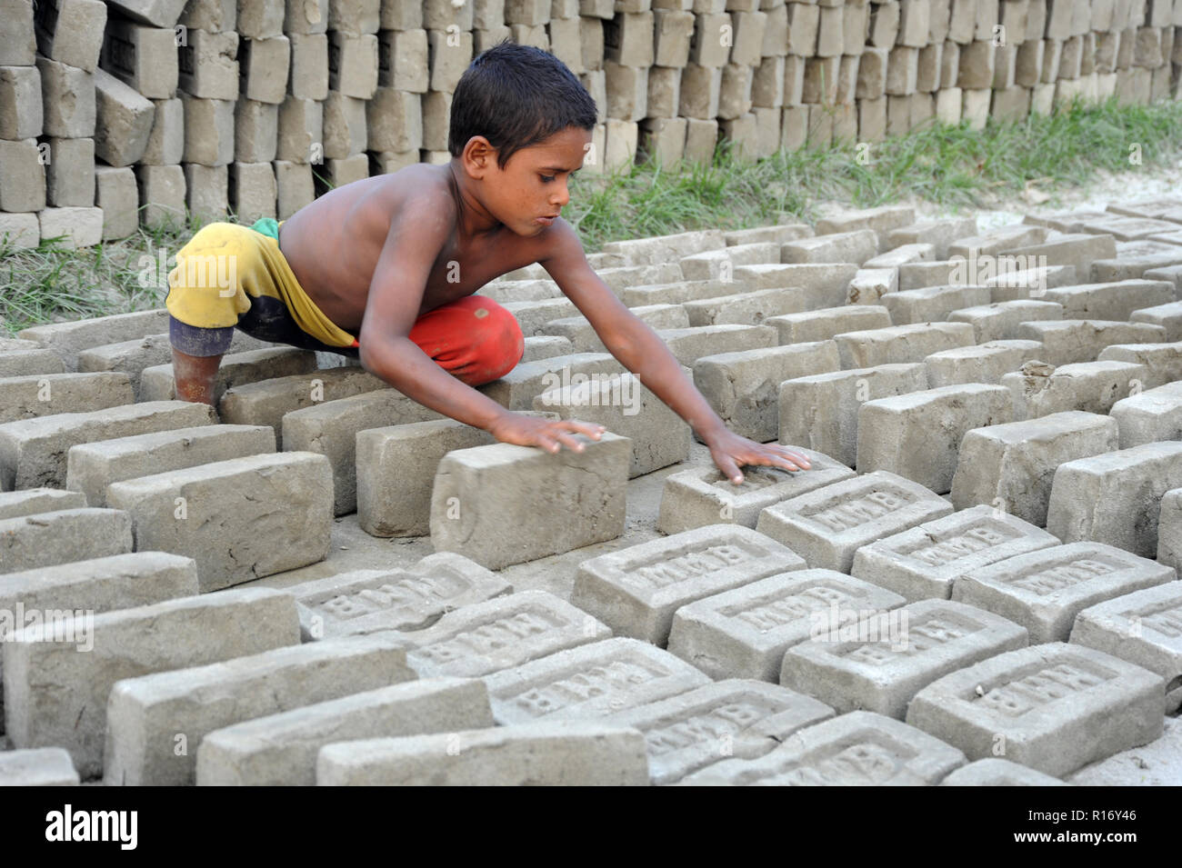 Dhaka, Bangladesh - November 15, 2009: Child labors work at the brick ...