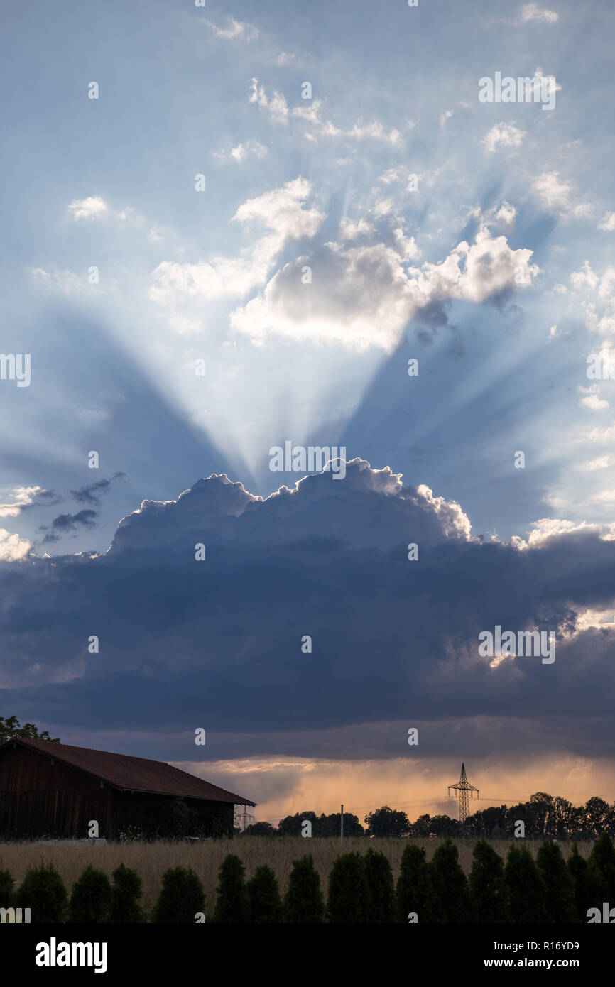Changing Weather with Sunbeams above Field with Hut, Germany Stock ...