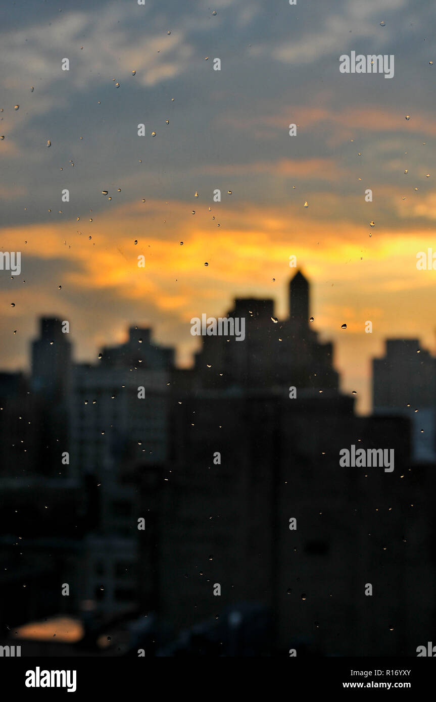 Rain drops on the window with unfocus view to Manhattan skyline during ...