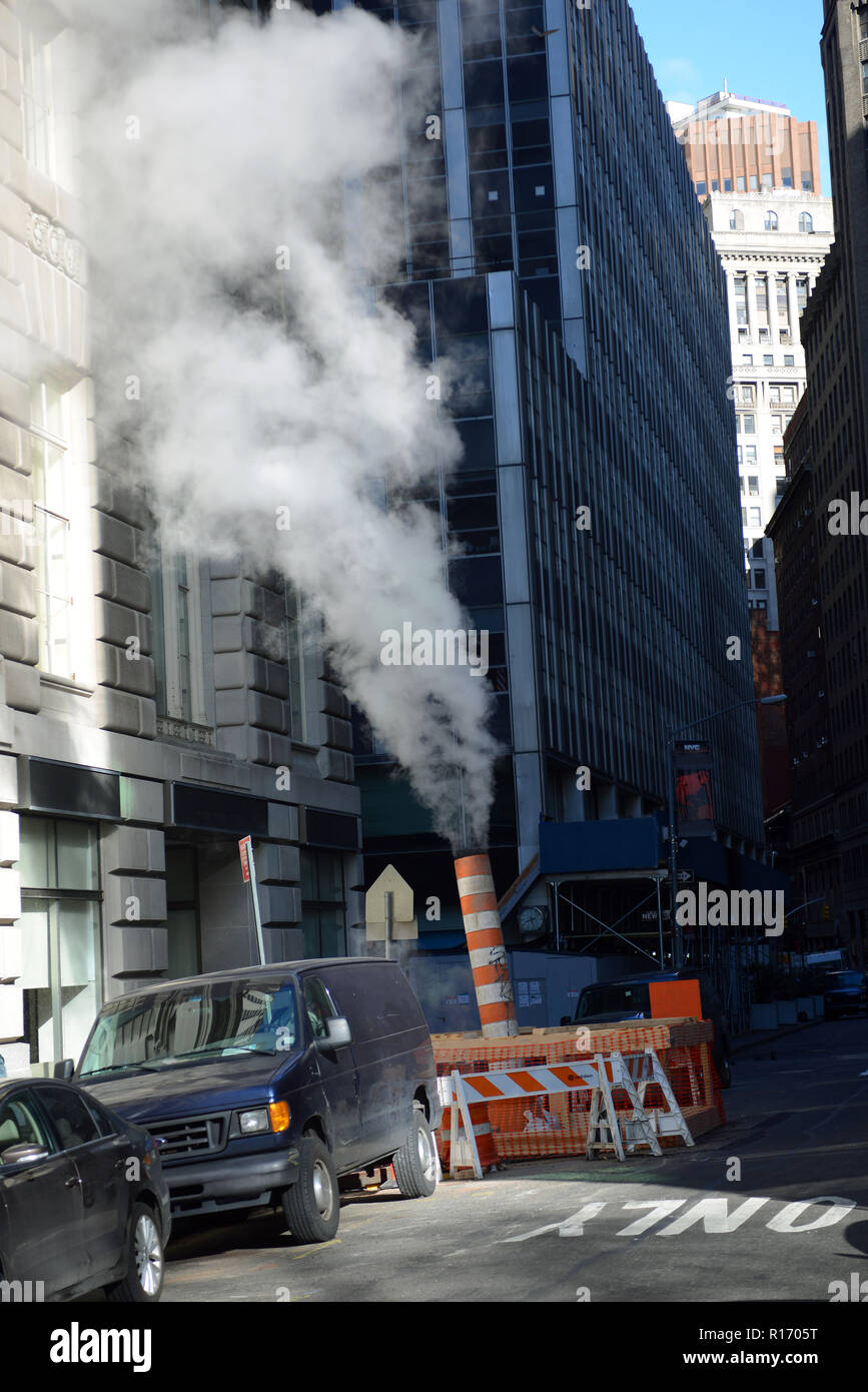 Steam venting from the street, utility pipe hot steam to building for ...