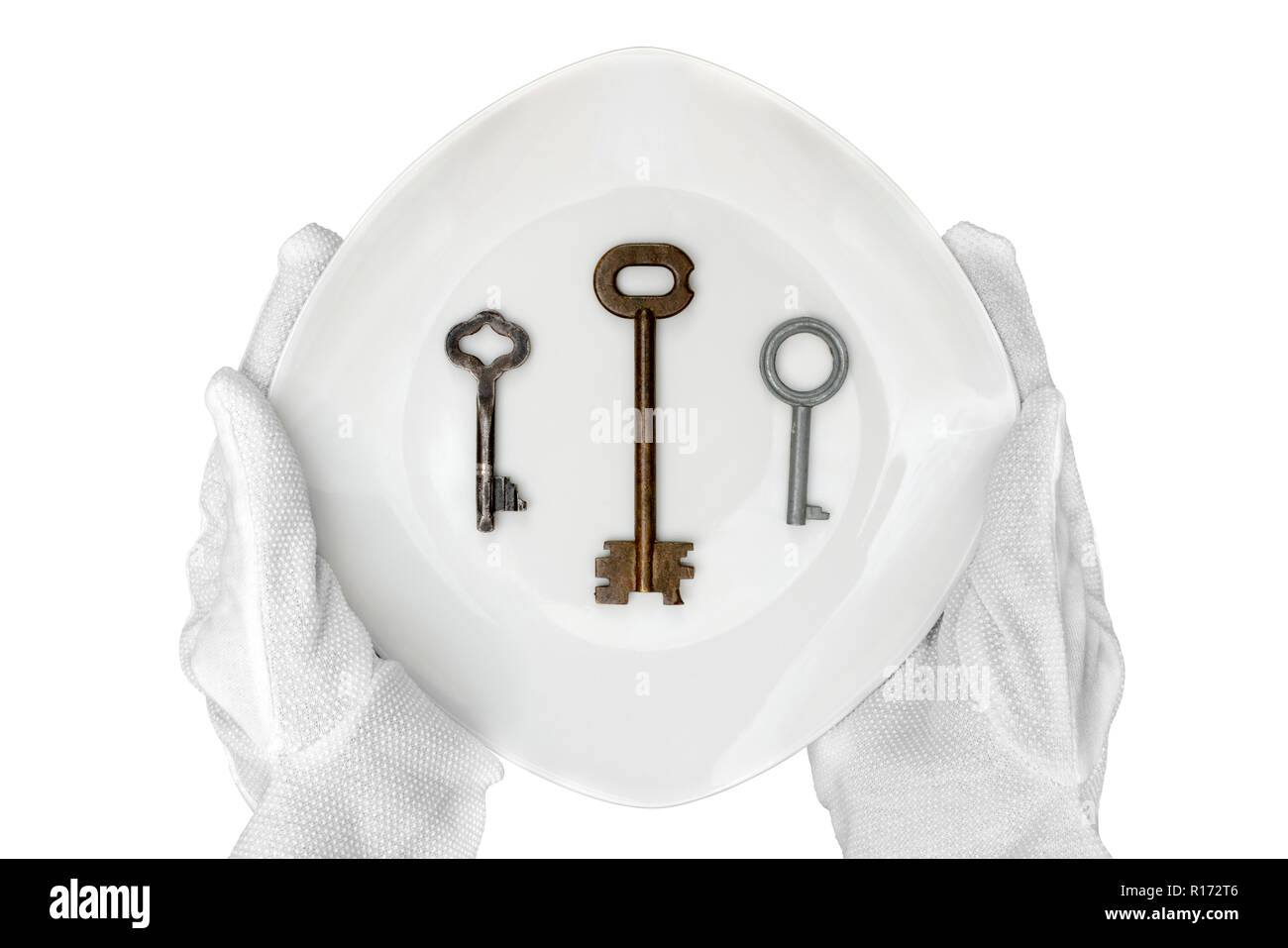 Three metal keys on a white plate Stock Photo - Alamy