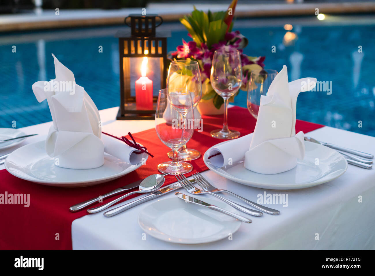 Romantic Candlelit Dinner Table; Poolside with Table Set Stock Photo ...