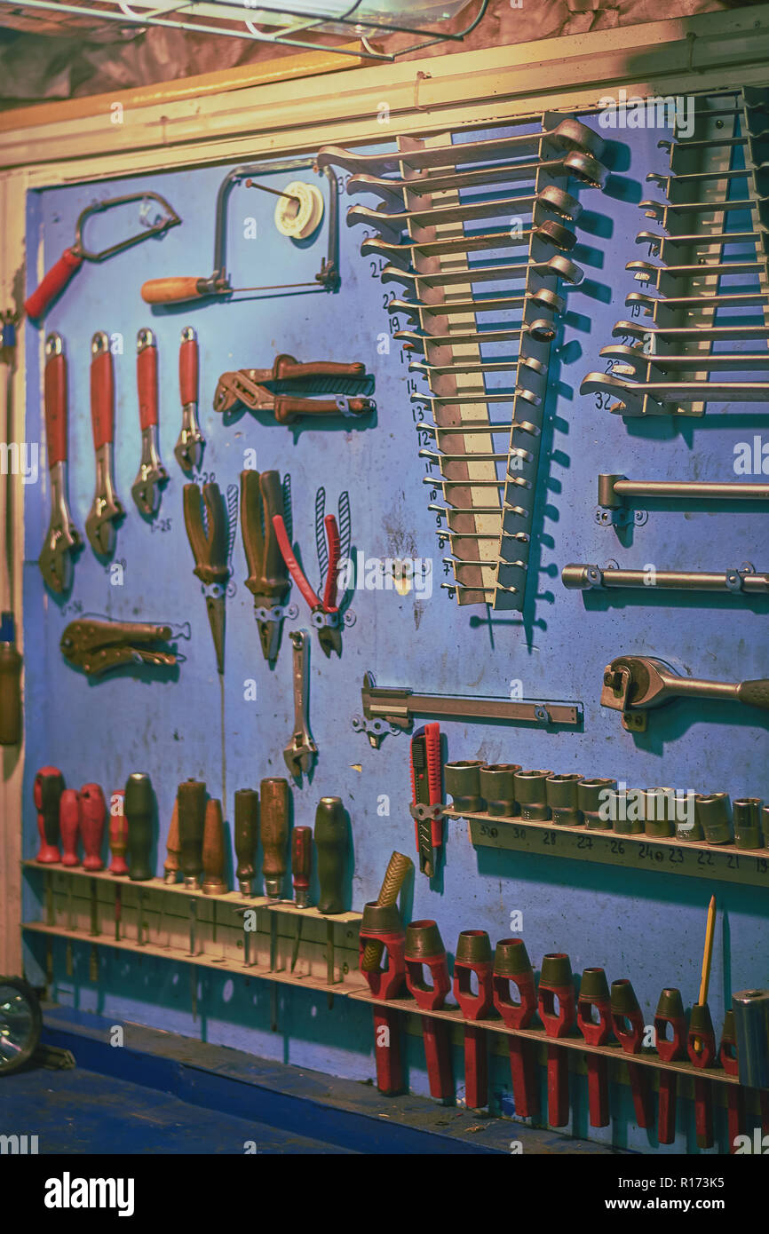 Blue board in ship's engine workshop with plent different types of ...