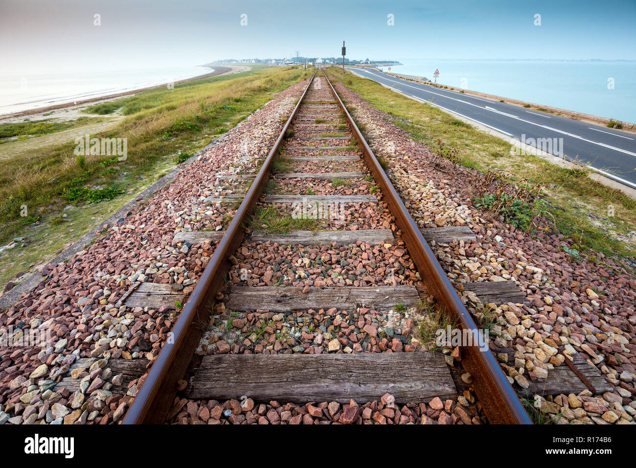 Straight railway perspective at dusk, in the Quiberon peninsula ...