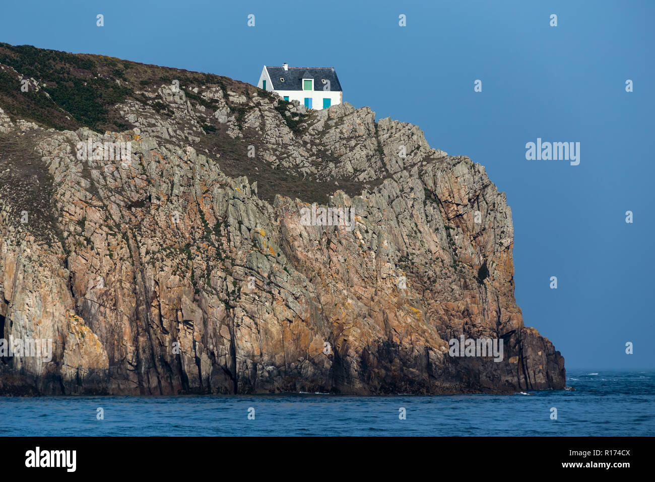 Home sitting on a high cliff in the Ushant island (aka Ouessant ...