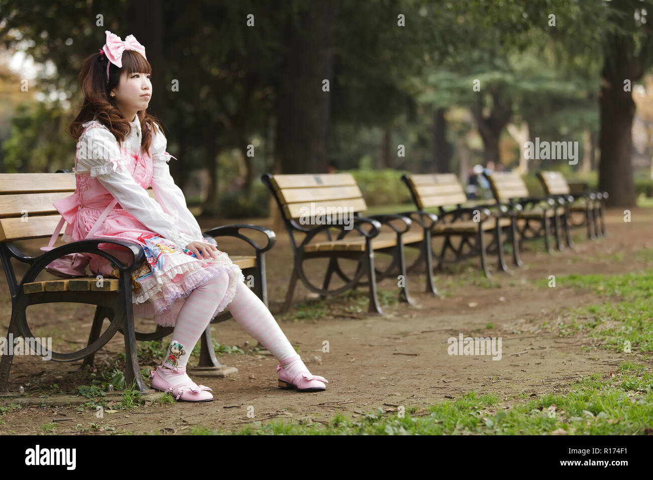 Japanese girl in lolita cosplay fashion sitting on a bench, Tokyo Stock ...