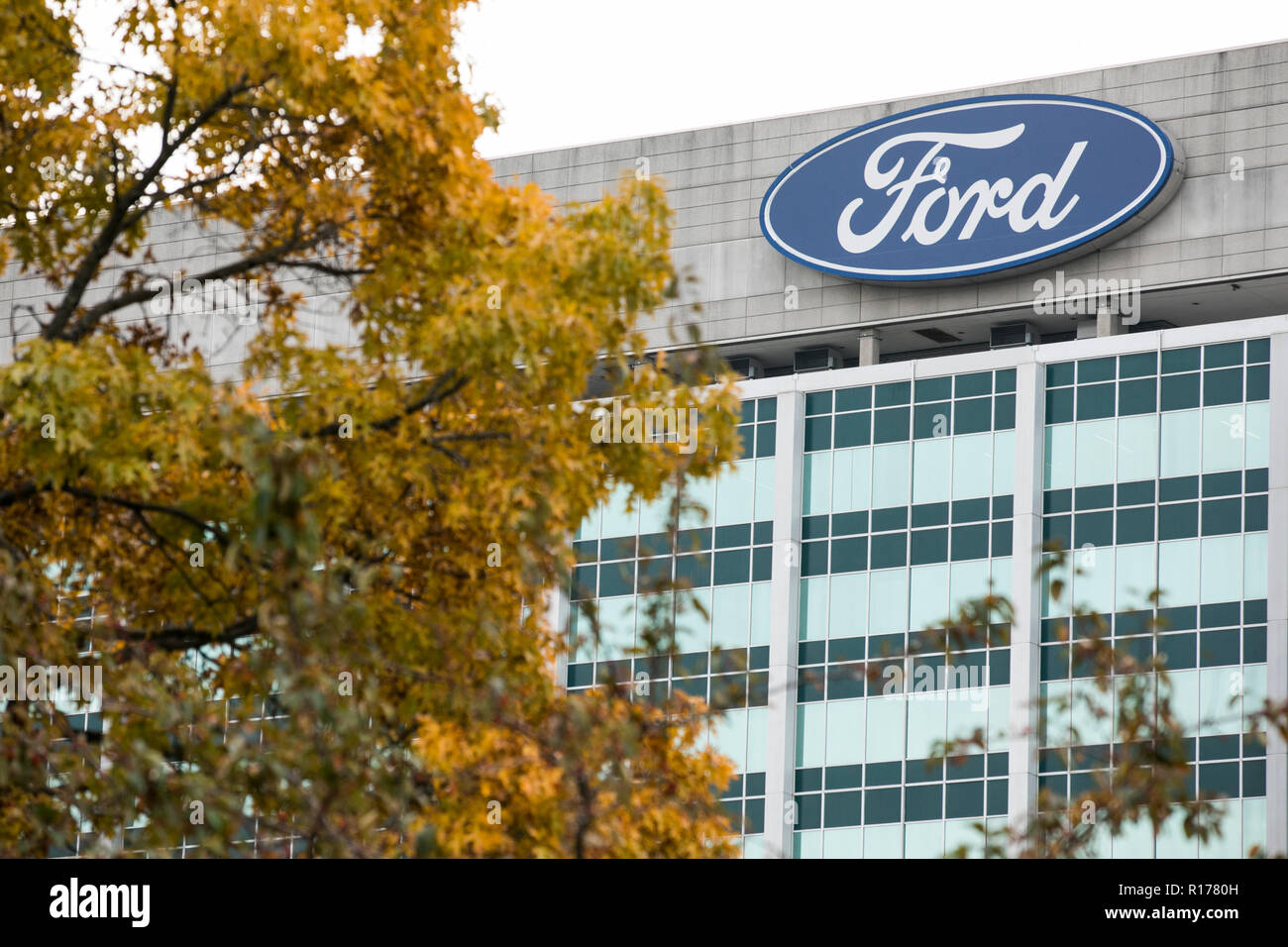 A logo sign outside of the headquarters of the Ford Motor Company in ...