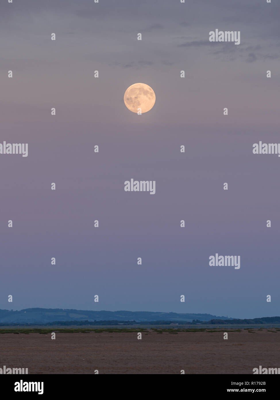 Rising full moon Stock Photo - Alamy