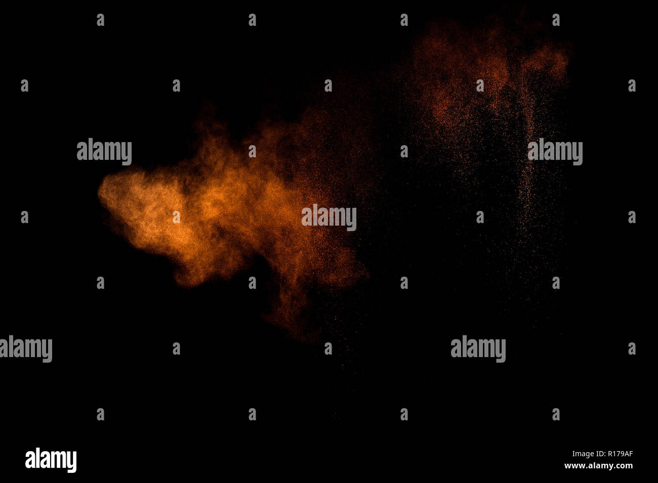 Orange powder explosion on black background. Colored powder cloud ...