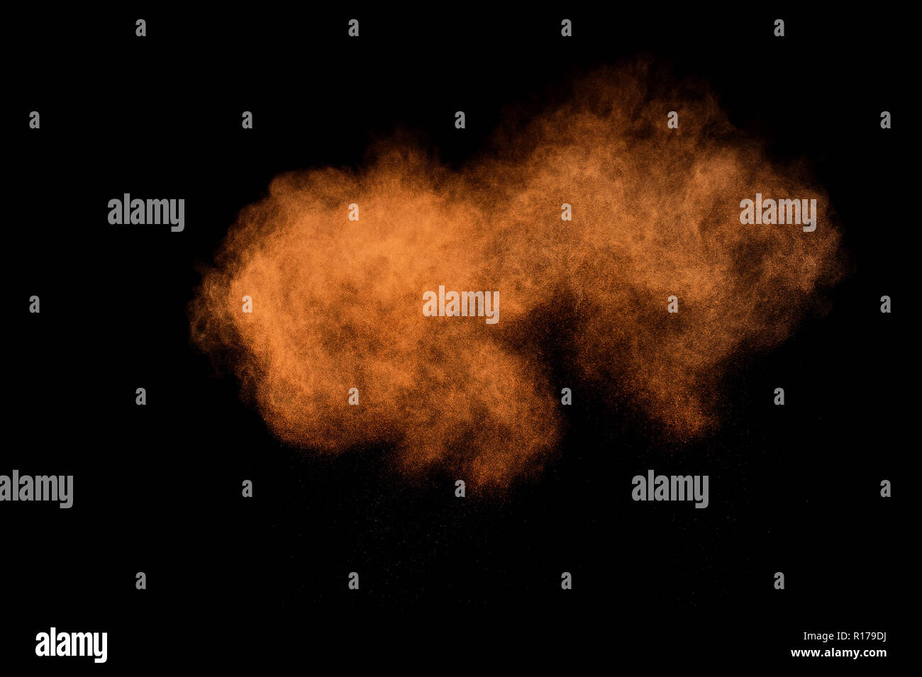Orange powder explosion on black background. Colored powder cloud ...
