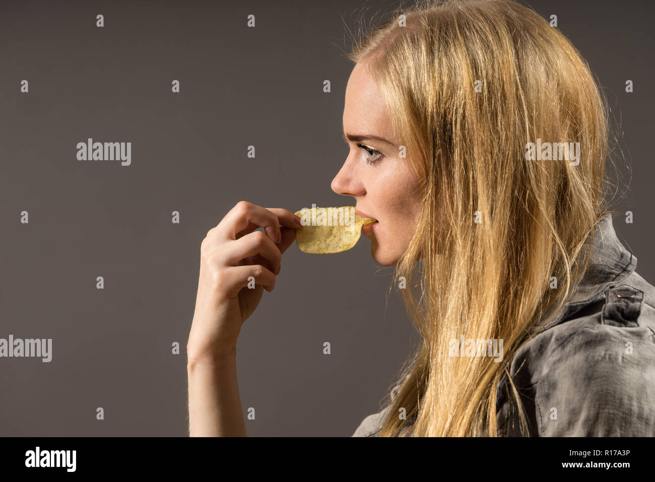 Teen girl eating chips hi-res stock photography and images - Alamy