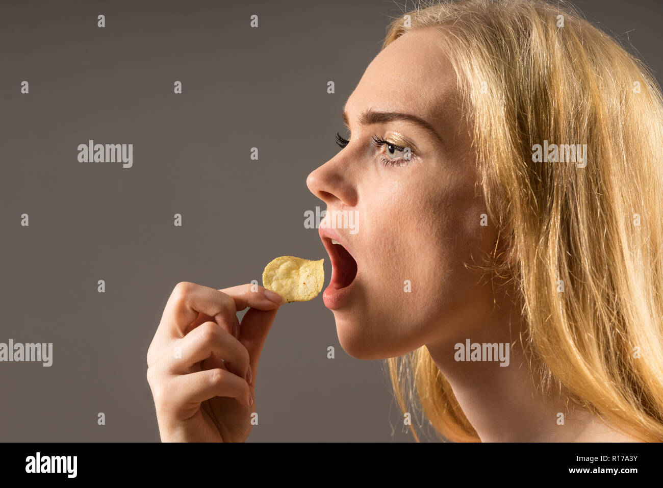Junk food and unhealthy eating concept. Portrait of young woman who ...
