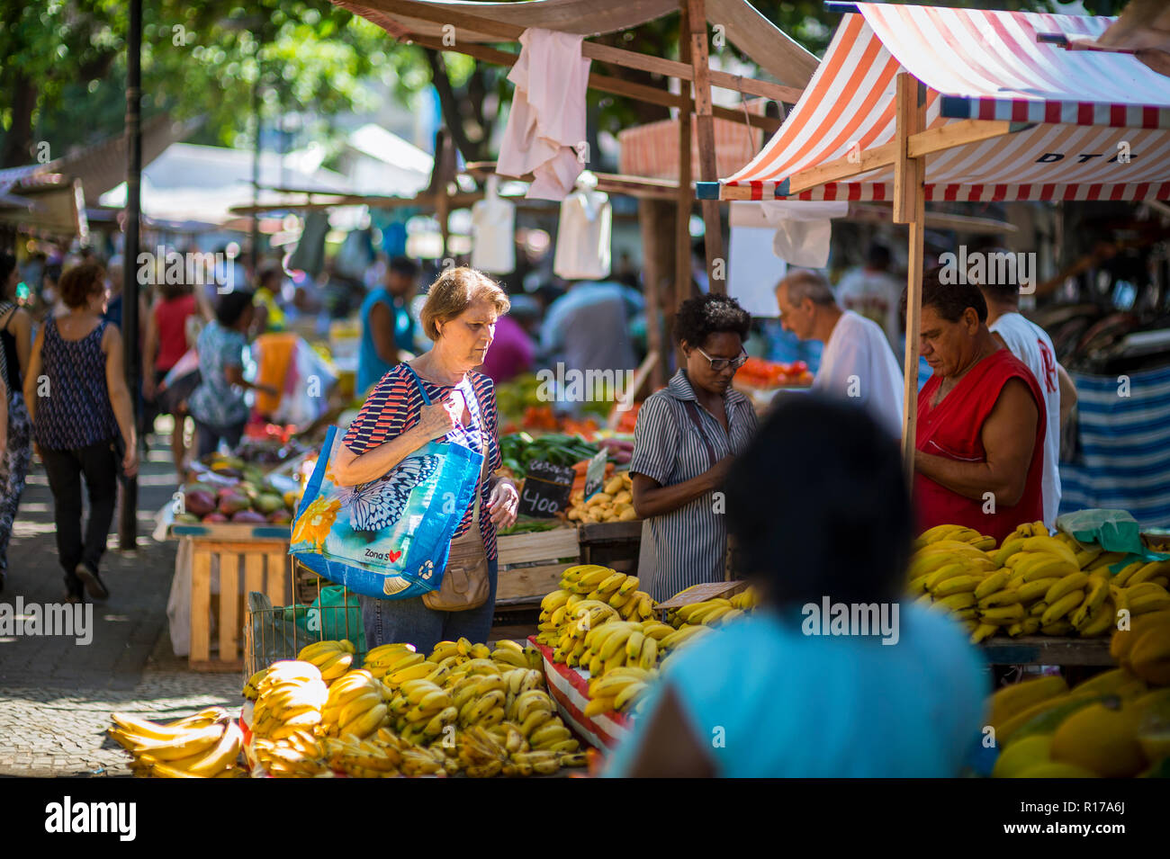 RIO DE JANEIRO - CIRCA MARCH, 2018: Vendors arrange displays of ...
