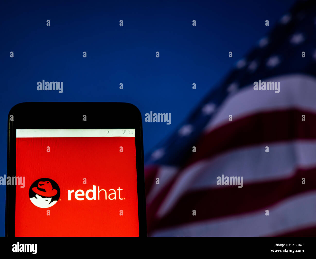 Red Hat Software company logo seen displayed on smart phone. Red Hat ...