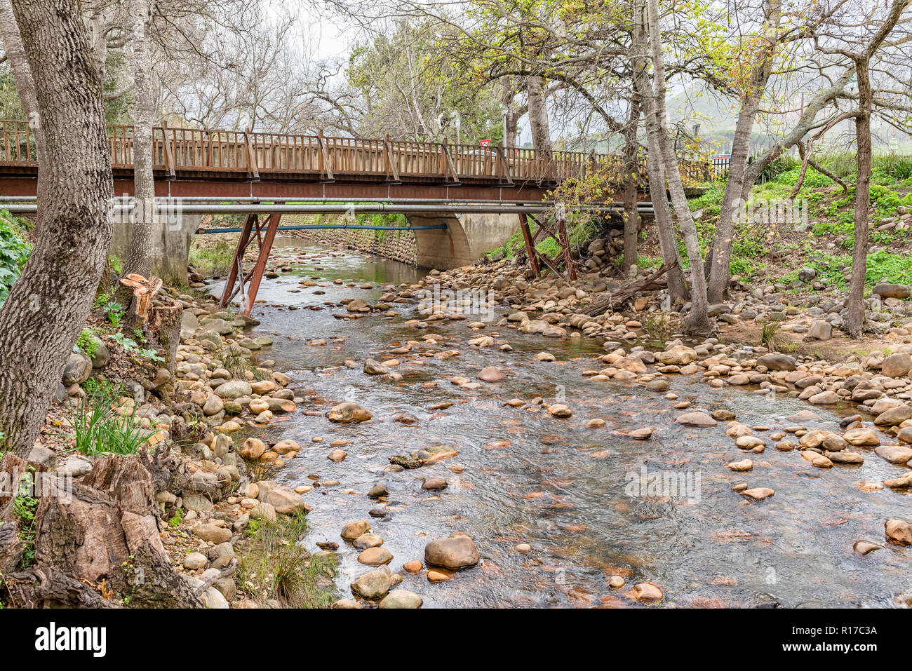 An historic steel and wood pedestrian bridge and a concrete road bridge ...