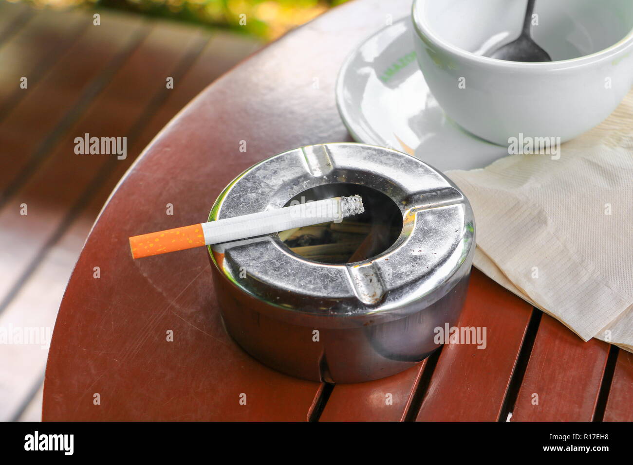 Cigarette in ashtray Placed on table wood background select focus with ...