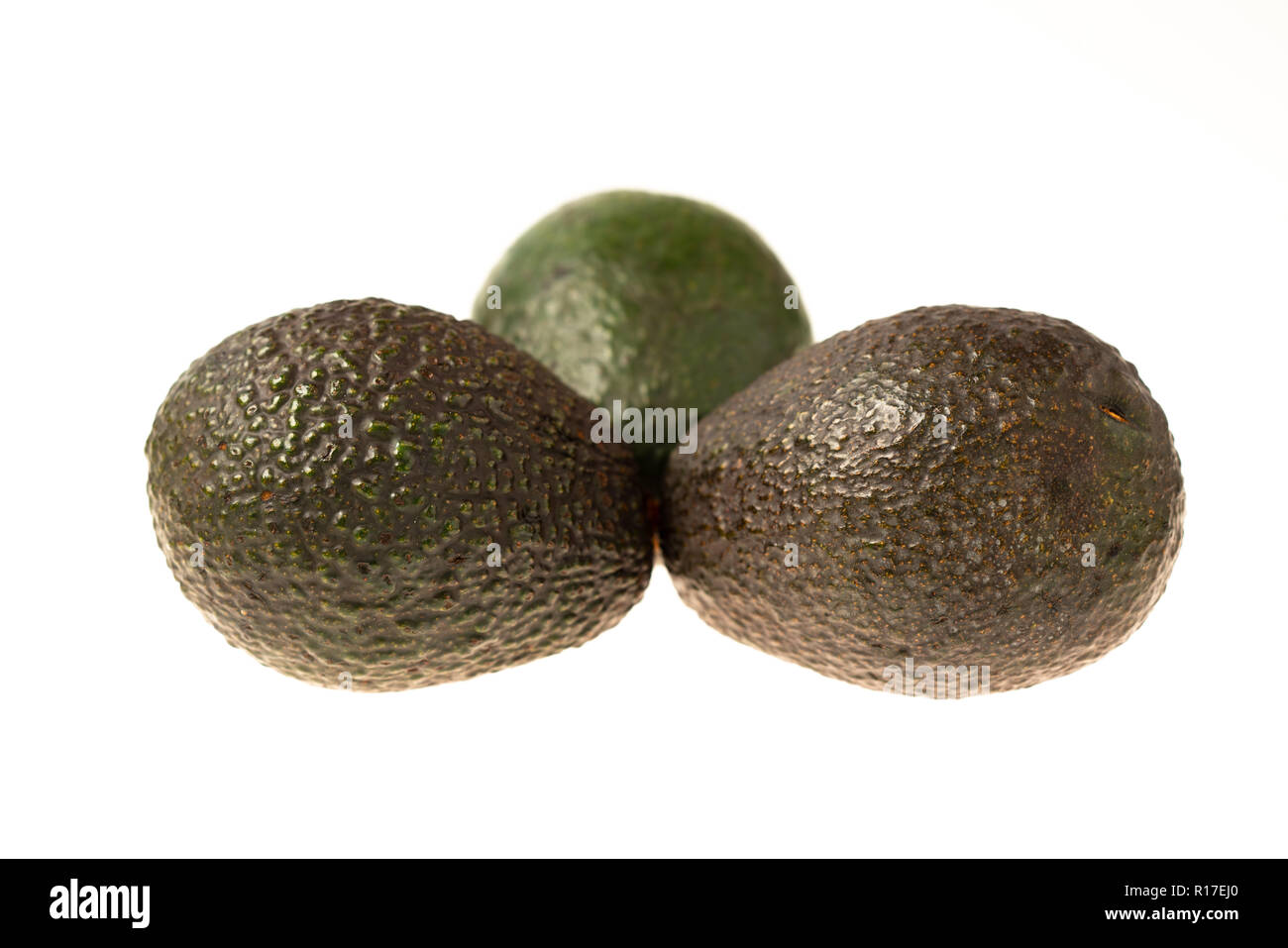 Three avocados arranged on white background Stock Photo - Alamy
