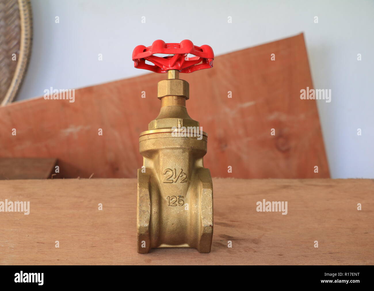 brass valve with red knob in a factory plumber on wooden floor ...