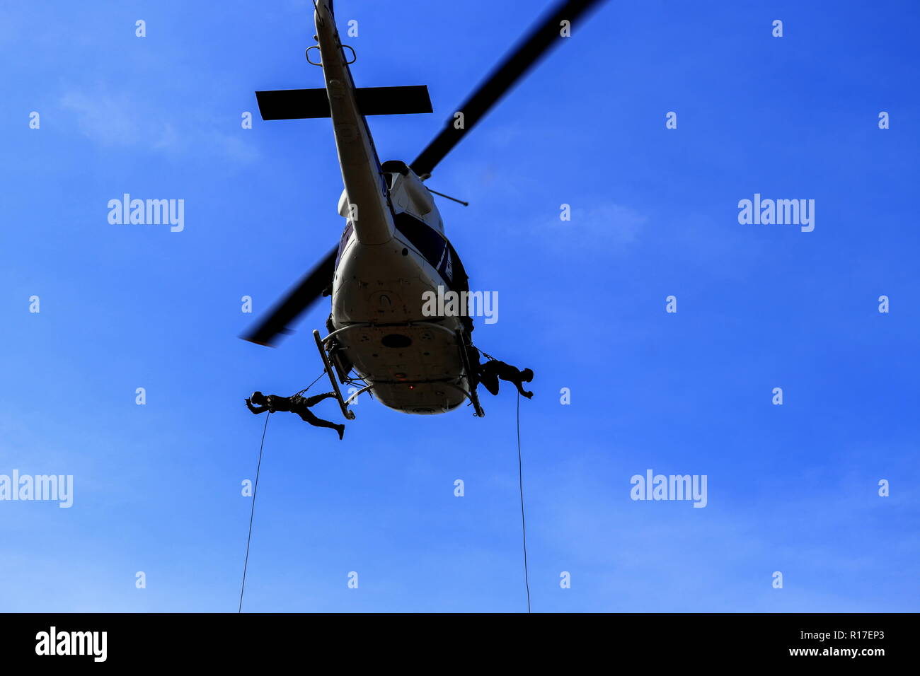 silhouette Soldier Jump rope from helicopter in blue sky Stock Photo ...