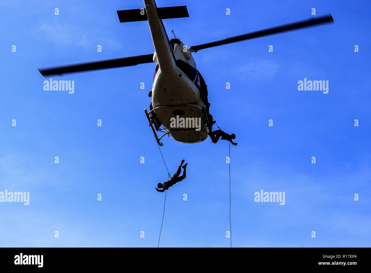 silhouette Soldier Jump rope from helicopter in blue sky Stock Photo ...