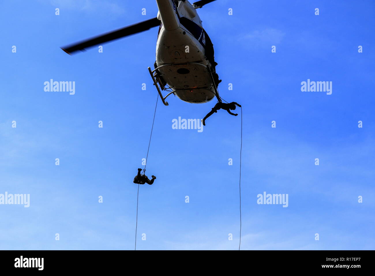silhouette Soldier Jump rope from helicopter in blue sky Stock Photo ...