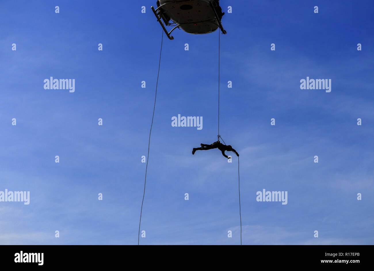 silhouette Soldier Jump rope from helicopter in blue sky Stock Photo ...