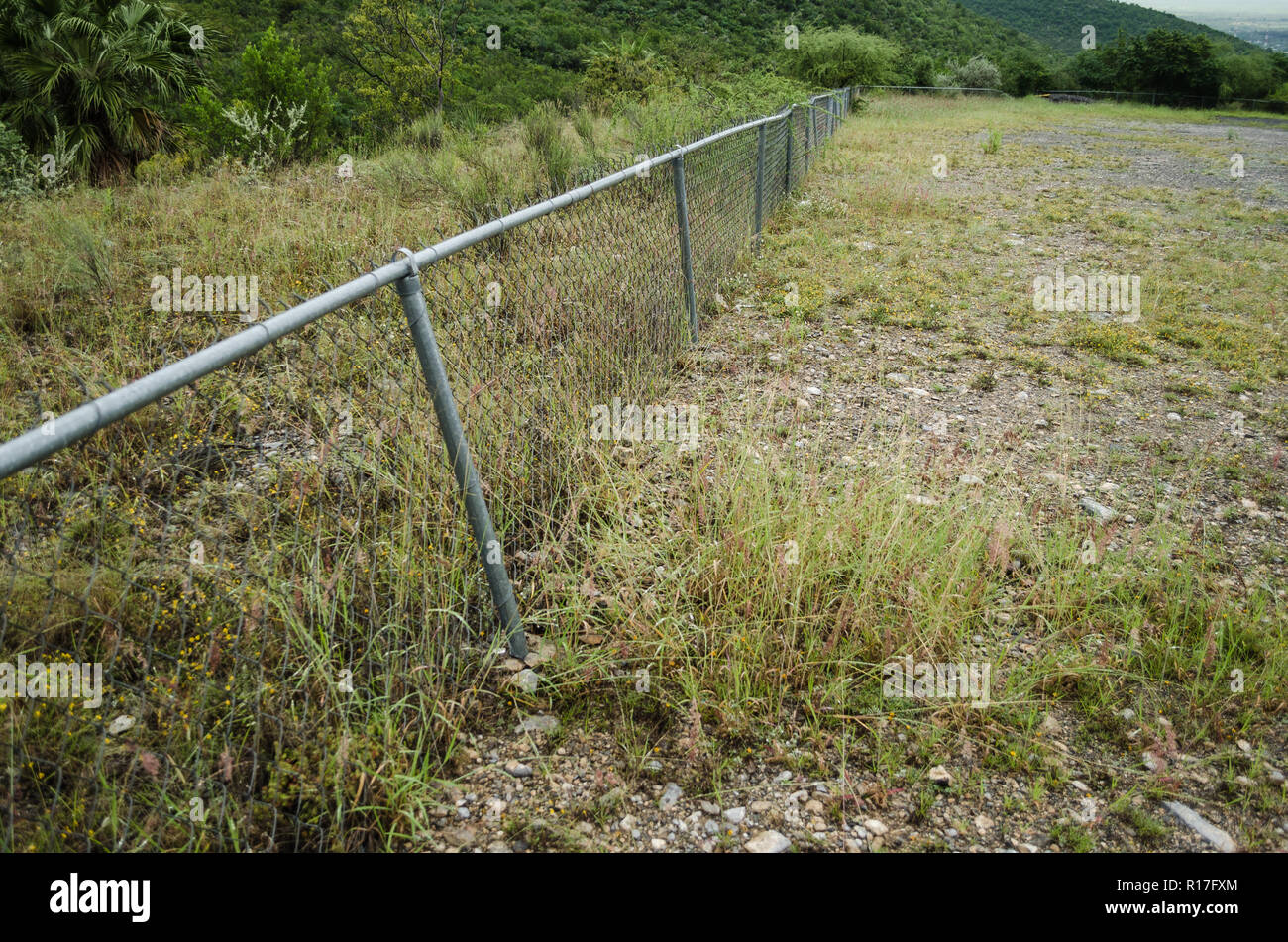 close to metal with metal mesh obstructing the passage to nature, metal ...