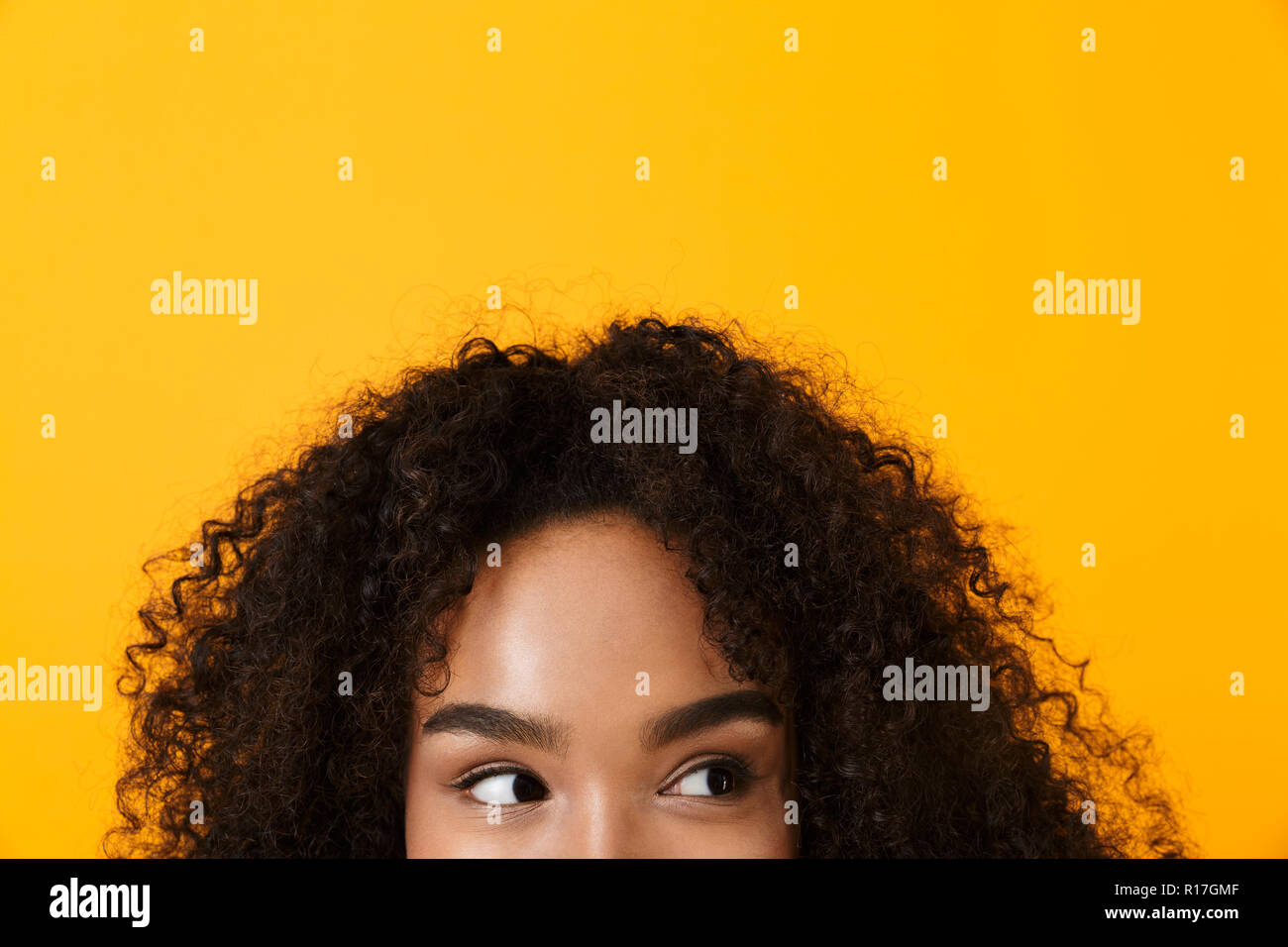 Cropped photo of young african woman posing isolated over yellow ...