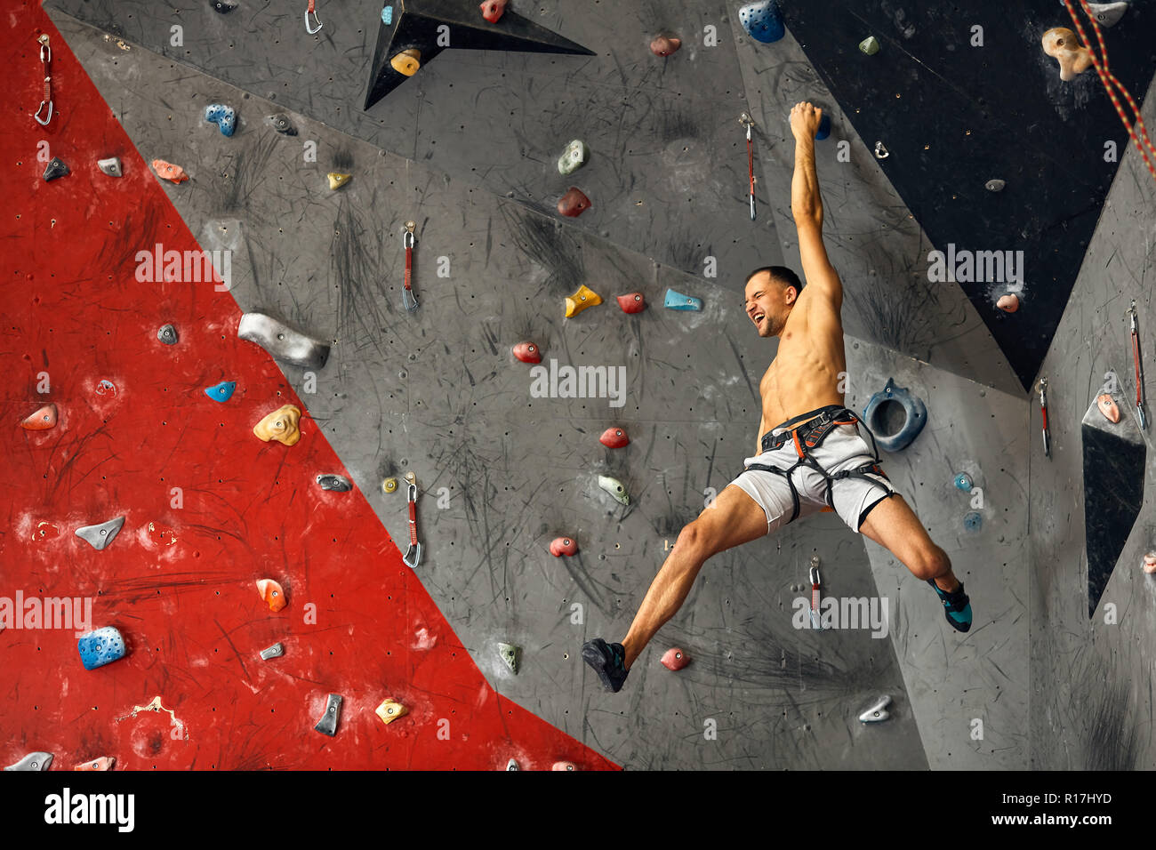 Panoramic man bouldering at an indoor climbing centre Stock Photo - Alamy
